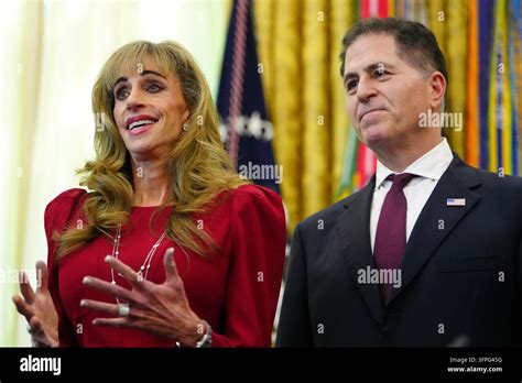 Michael Dell Listens As His Wife Susan Dell Speaks During An Event With