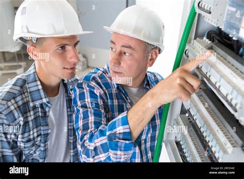 Electricians Connecting Wires In Distribution Board Stock Photo Alamy