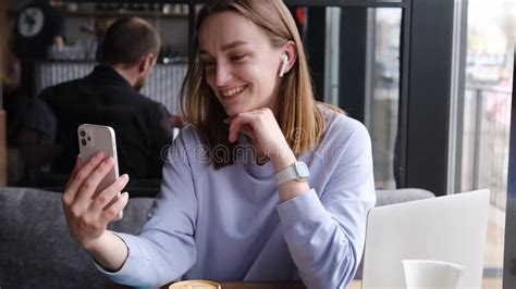 Young Beautiful Girl Takes A Selfie With A White Phone Stock Footage