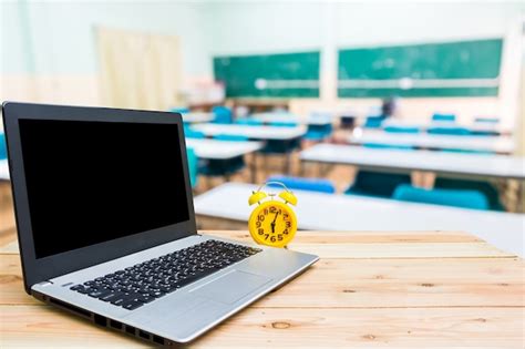 Premium Photo Computer On The Table Blur Image Of Classroom As