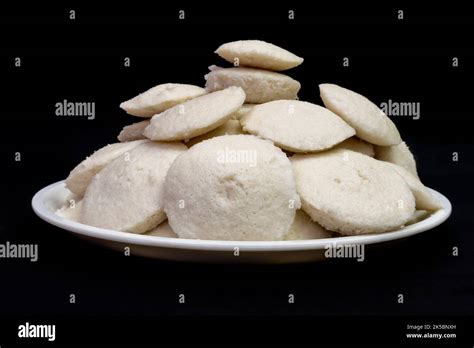 Idly In White Plate With Sambar In Red Bowl Isolated On Black