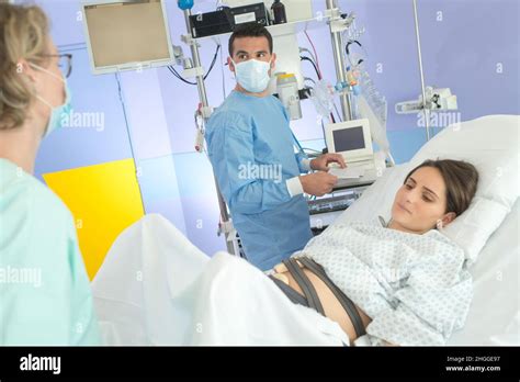 Pregnant Woman With Electronic Fetal Monitor Attached To Belly Stock
