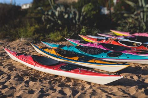 View Of Colorful Kayaking Equipment On A Sandy Beach Process Of