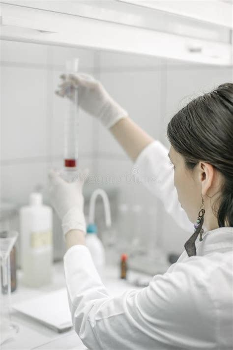 Medical Laboratory Scientists Holding A Test Tube With Sample Stock