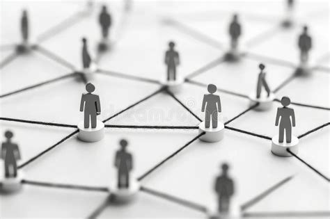 black and white composition of miniature figures standing on a network