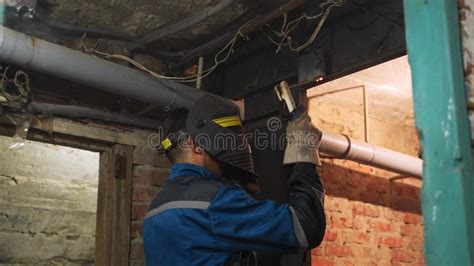 Close Up Side Shot Of Professional Welder In Safety Suit And Protective