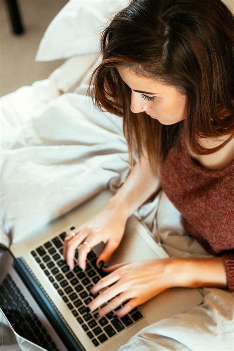 Babe Brunette Woman Typing On Laptop In Bed By Stocksy Contributor Luke Mattson Stocksy