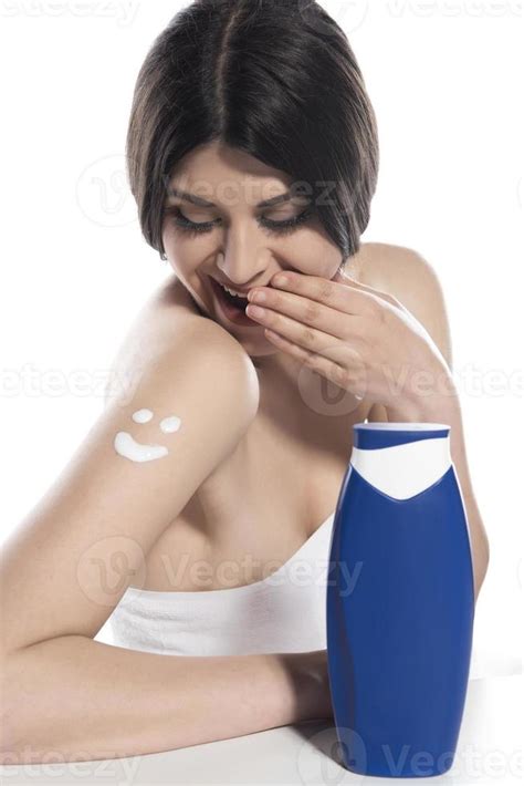 Beautiful Skinned Woman Applying Body Lotion On White Background