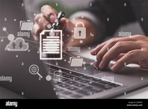 On A Laptop Computer In The Workplace An It Expert Is Setting Up A Document Management System