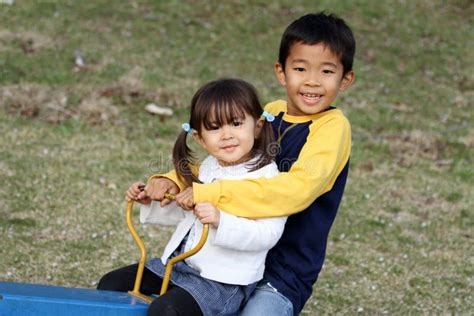 Japanese Brother And Sister On The Seesaw Stock Image Image Of