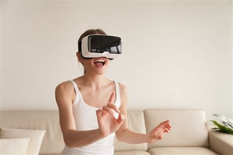 Free Photo Excited Young Woman Wearing Vr Headset Touching Virtual