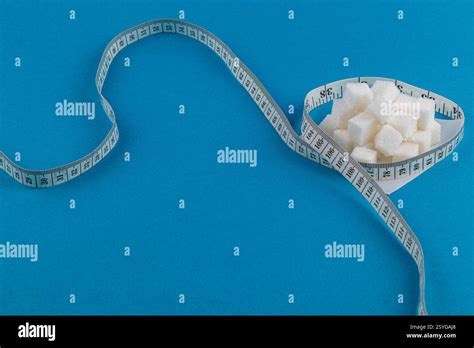 White Sugar Cubes Are Arranged In A Heart Shaped Bowl Accompanied By A Measuring Tape