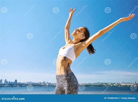 Happy Smiling Woman With Tanned Slim Body And Tattoo Posing On The