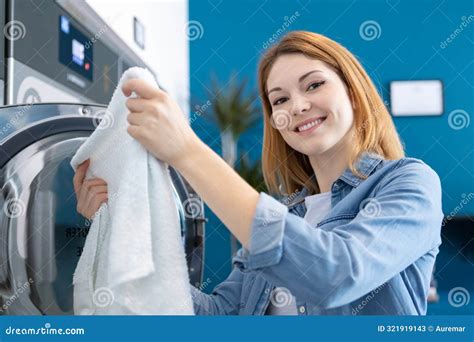 Happy Housewife Woman In Laundry Room With Washing Machine Stock Image