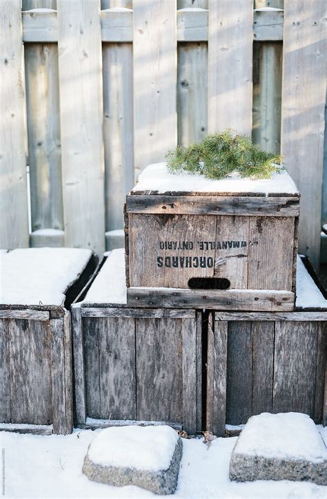 Wooden Crates In A Garden Covered In Snow By Stocksy Contributor Amanda Large Stocksy