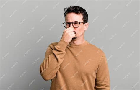 Premium Photo Feeling Disgusted Holding Nose To Avoid Smelling A Foul