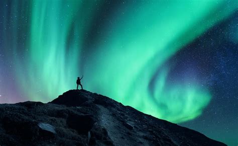Premium Photo Northern Lights And Silhouette Of Standing Man With