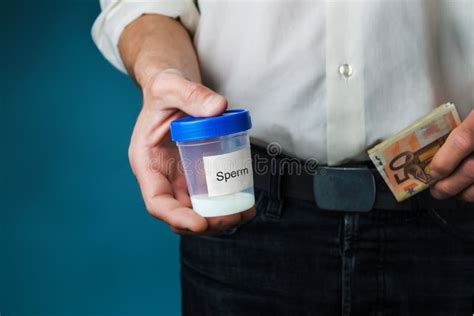 Money And Container With Sperm In Hands Of Man Concept Of Donating