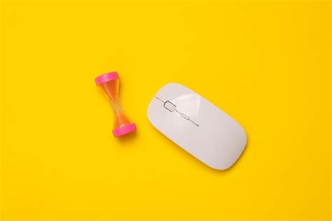 Premium Photo Pc Mouse With Hourglass On Yellow Background Top View