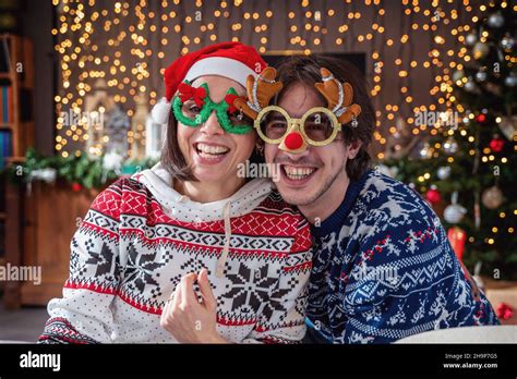 Young Couple Of Lovers Celebrating Having Fun On Christmas Holy Night