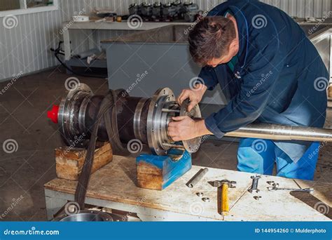 Worker Assembles Machine Part In A Factory Editorial Image Image Of