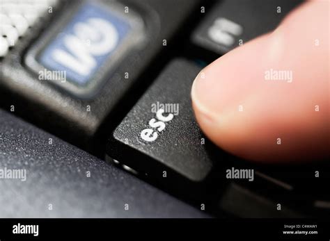 Finger Pushing Escape Key Stock Photo Alamy