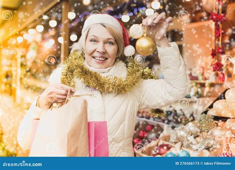 Smiling Woman Is Buying Toys For X Mas Tree In The Market Stock Image