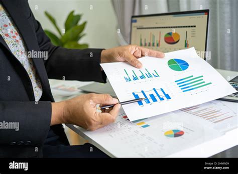 Asian Accountant Working And Analyzing Financial Reports Project