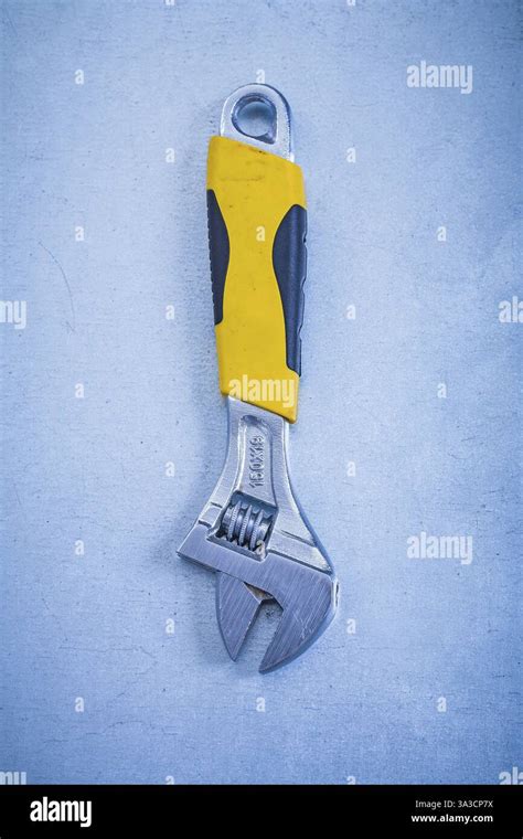 Stainless Adjustable Spanner On Metallic Background Construction