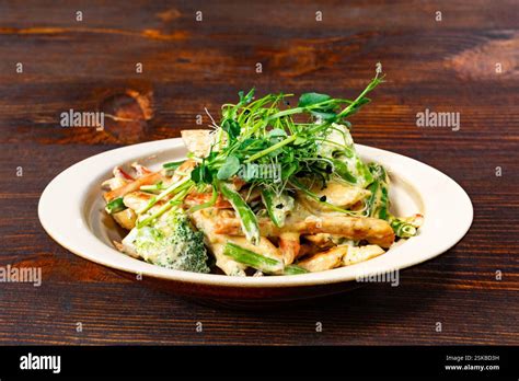 A Delicious Bowl Of Mixed Vegetable Pasta Is Garnished With Fresh