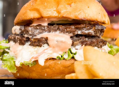 Hamburger With Pork Beef And Vegetables Is In The Bread Overlapping Layers Stock Photo Alamy