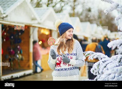 Happy Young Woman On Christmas Market In Paris France Girl Eating