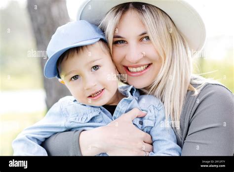 Pregnant Mother And Her Little Son Walking And Hugging In The Forest And Funny Spending Time