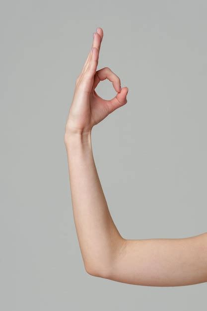 Premium Photo Female Hand Showing Ok Sign On Gray Background