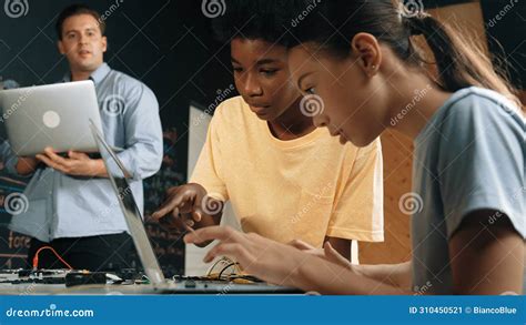 Girl Programing Or Coding System While African Boy Fixing Model
