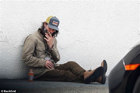 Keanu Reeves Puffs On A Cigarette As He Takes A Break On The Floor