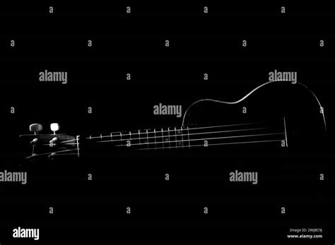 The Ukulele Musical Instrument Was Photographed Against A Dark