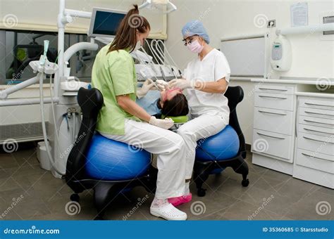 Dentist Assistant And Patient In Dental Clinic Stock Image Image Of