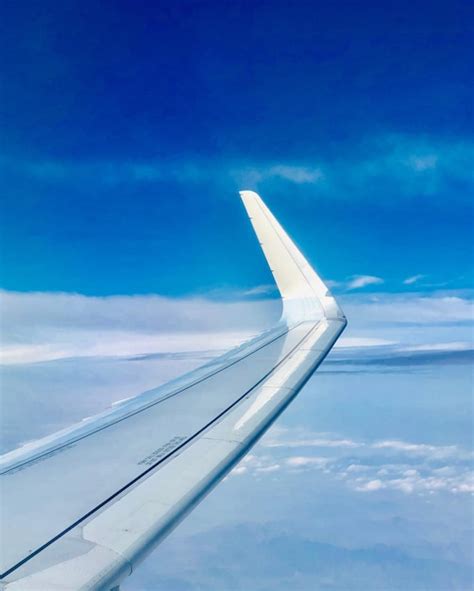 Premium Photo View Of Airplane Flying In Sky