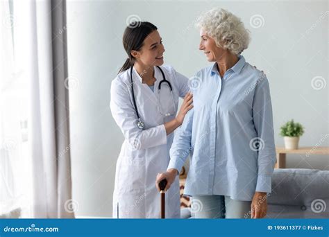 Young Physiotherapist Woman Giving Massage To African American Man At