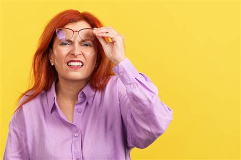 Premium Photo Aged Redheaded Woman Taking Off Her Glasses To See