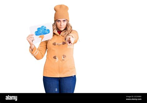 Young Caucasian Woman Holding Thunder Draw Pointing With Finger To The Camera And To You