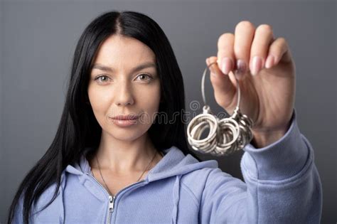 Woman Holds A Finger Sizing Gauge For Measuring Rings She Is Using A Ring Sizer Tool Set To