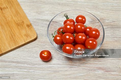 유리 그릇에 체리 토마토와 다른 하나는 근처 나무 테이블 표면에 도마의 가장자리 근처 0명에 대한 스톡 사진 및 기타 이미지