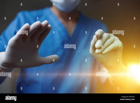 Surgeon Makes Plastic Surgery On The Background Of The Operating Light
