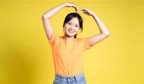 Premium Photo Asian Girl Posing On Yellow Background