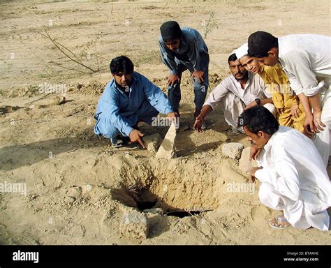 Residents Of Natha Khan Goth Point A Grave Ruin At Graveyard After Land