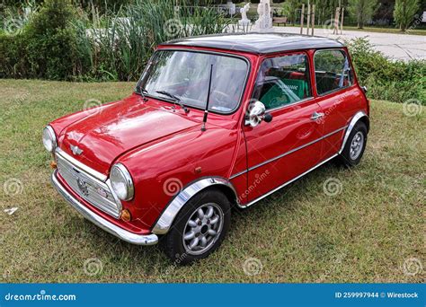 Vintage Red Austin Mini Classic Car Parked On A Grassy Meadow Editorial
