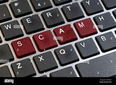 A Computer Keyboard With Red Keys Spelling The Word Scam Stock Photo