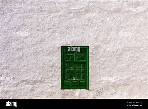 Rustic Green Wooden Door In Weathered White Wall Stock Photo Alamy